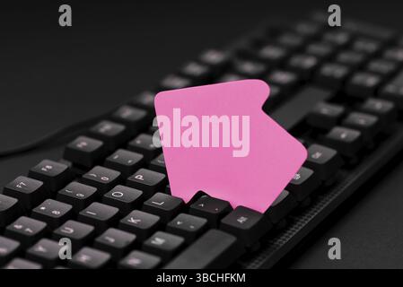 Sticker lying on black keyboard. Important message written over paper ...