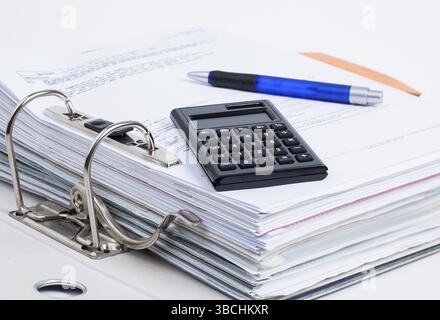Calculator and open notepad close up on wooden desk Stock Photo - Alamy