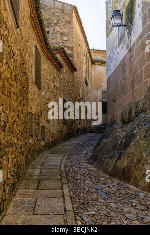 Narrow pedestrian cobblestone street leading through the historic old ...