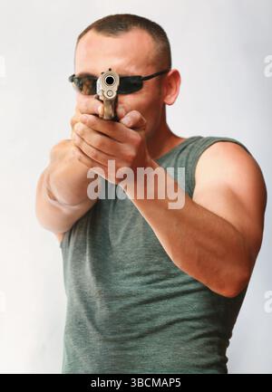 contractor private security guard aiming a pistol, front view down the ...