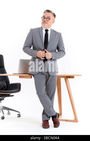 older business professional standing upright at a desk Stock Photo - Alamy