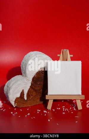Heart shaped coconut flavor croissant on red background with copy space ...