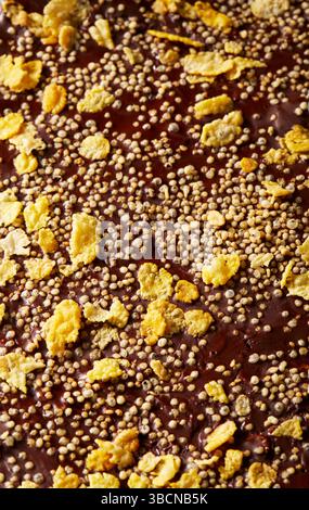 Chocolate bark with puffed quinoa and cornflakes on parchment Stock ...