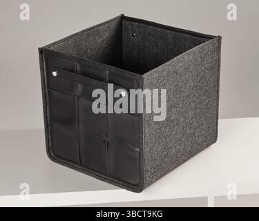 Stylish black and grey felt storage box with leather details on white ...