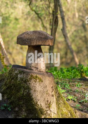 Tree stump carved into the shape of a toadstool in woodland, Ticknall ...
