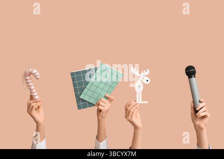 Journalist's female hands with Christmas decorations, camera and ...