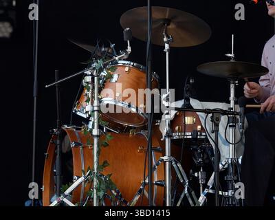 a Live music stage setup with drum set and professional lighting, ready ...