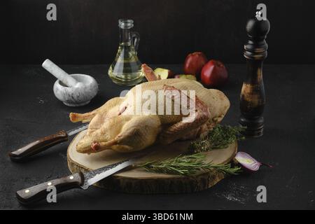 Traditional raw gourmet duck leg offered with herbs as close-up on a ...