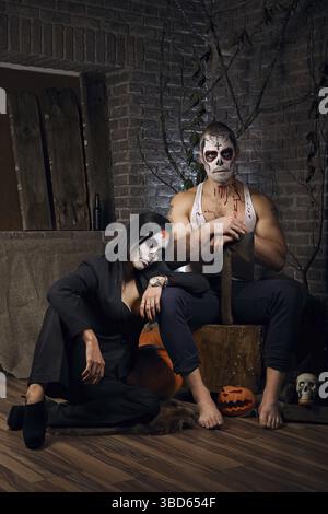 Portrait of a young man with a skull makeup for Halloween on a black ...