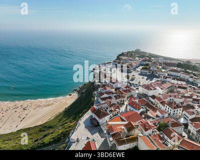 Aerial photo of Nazare atop cliffs with Praia da Nazare beach and ocean ...