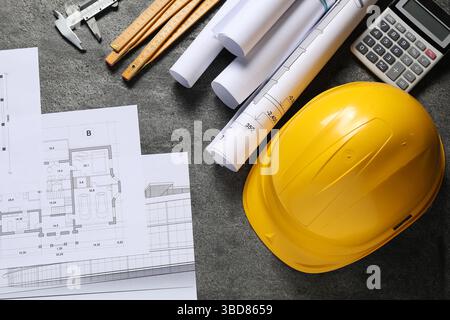 Hard hat, different engineering drawings, folding ruler and vernier ...