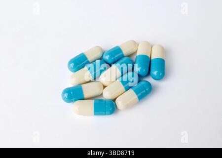 Blue and white medical capsules lined vertically Stock Photo - Alamy