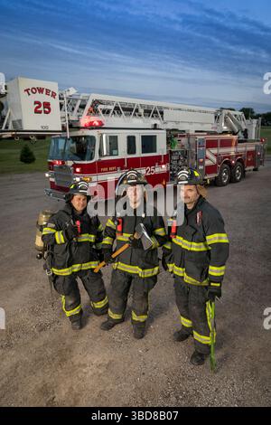 Family of firefighters posing against fire engine, New Holstein ...