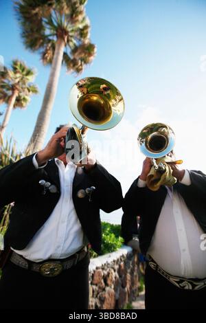 Mariachi band members in traditional attire with their musical ...