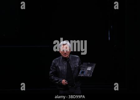NVIDIA CEO Jensen Huang, speaks to a reporter after a press conference ...