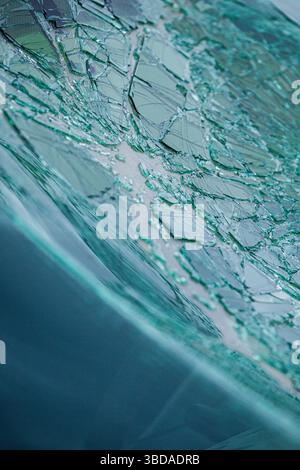 Fractured windshield with radiating cracks. Close-up of spiderweb ...
