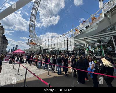 Very busy queue for the London Eye on the South Bank in London, UK ...