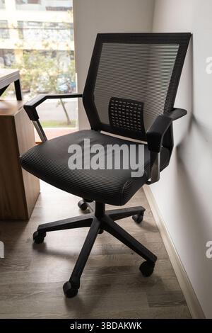 Modern elegant home workplace with black stationery, books, glass vase ...