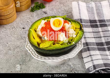 Avocado with red caviar and quil egg and soft cheese Stock Photo - Alamy
