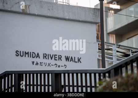 Asakusa, Tokyo, Japan 03-23-2025: Train and people crossing the river ...