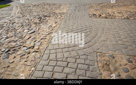 Two types of paving stones and cobblestones on a city road Stock Photo ...