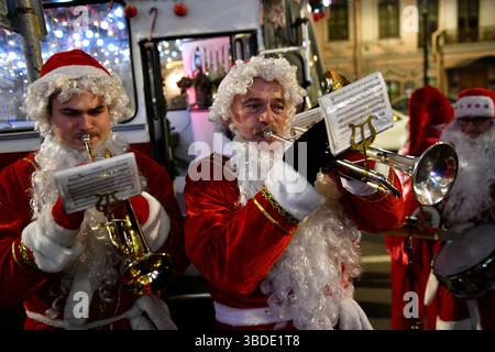 Men in Santa claus costumes playing music on a street of St Petersburg Russia Stock Photo - Alamy