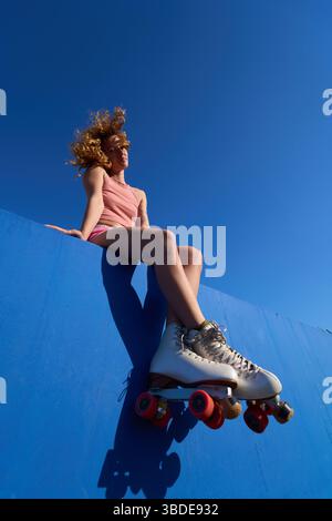 Young people roller-skating under railway arches by train station in ...