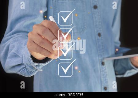Checklist concept. Businessman is marking checkboxes Stock Photo - Alamy