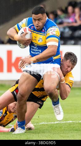 Sam Lisone of Leeds Rhinos is tackled during the Betfred Super League ...