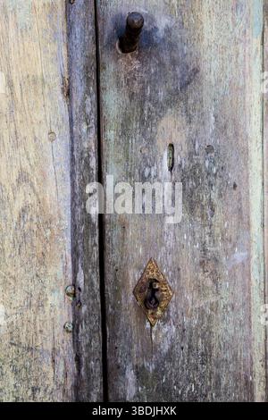 Old unpainted wooden gate of farmhouse basement, with rusty hardware ...
