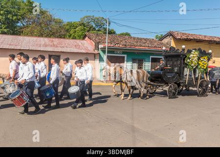 Funeral procession. Music group marching in front of a horse drawn ...