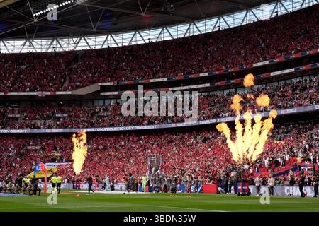 Pyrotechnics are set off as the teams make their way onto the pitch ...