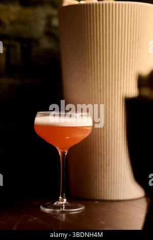 A close up of an alcoholic beverage depicting a cocktail glass filled ...