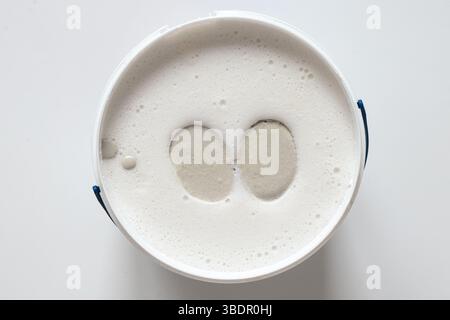 Hands pouring gypsum plaster in open form for mold casting for making ...