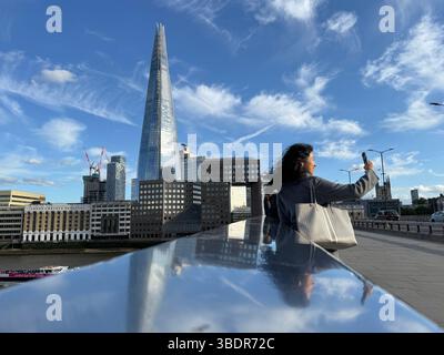 The Shard in London reflected in the hand rail of London Bridge ...