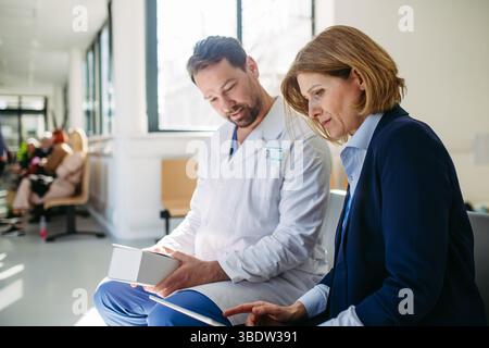 Pharmaceutical rep and doctor explaining new medication and ...