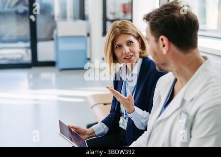 Pharmaceutical rep and doctor explaining new medication and ...