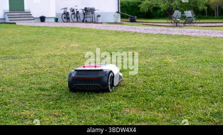 Robotic lawnmower without perimeter wire cutting perfect lawn Stock ...
