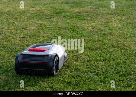Robotic lawnmower without perimeter wire cutting perfect lawn Stock ...