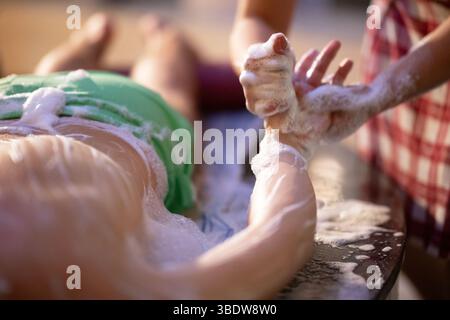 Hand Foam Therapy. Attendant gently washing patient hands with foamy ...