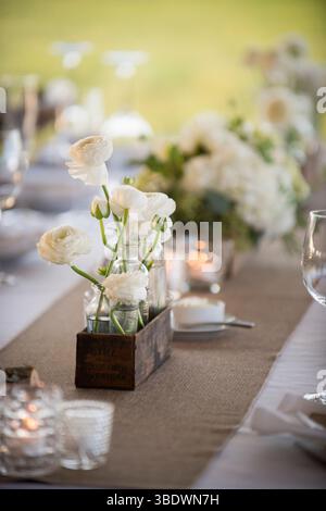 Rustic table setting with ranunculus flowers on concrete background ...