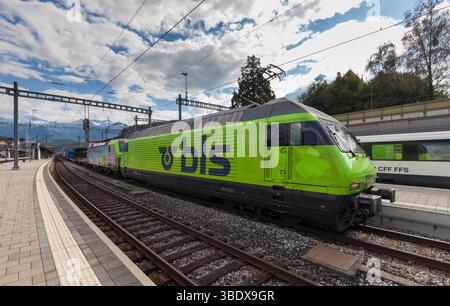 Electric locomotive hauling an intermodal piggyback freight train ...