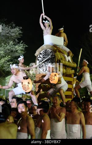 Men in loincloths performs a ritual for good luck to residents during ...