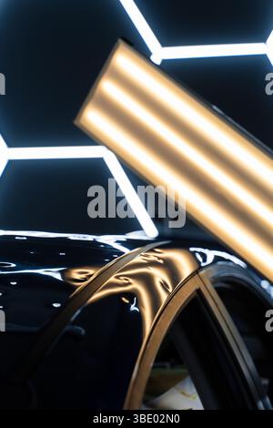 Car panel shows multiple dents under PDR lighting, used in paintless ...