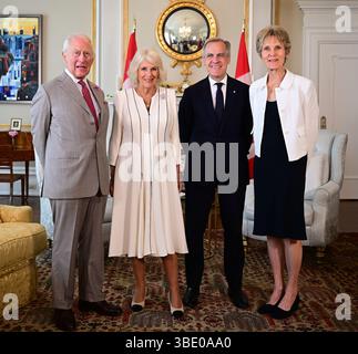 Prime Minister Mark Carney and wife Diana Fox Carney place a wreath at ...