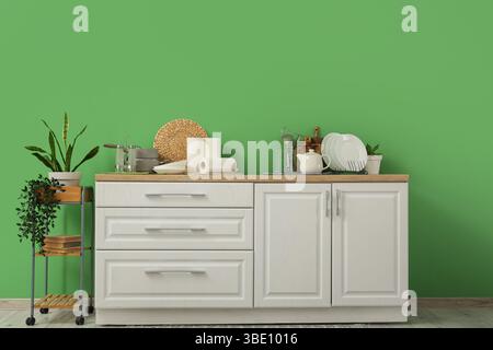 Counters with different utensils near white wall in kitchen interior ...