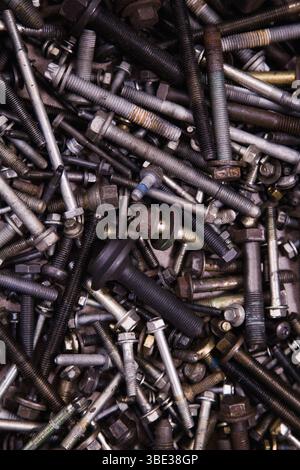 Background with different sizes of bolts, screws and nuts on a neutral ...