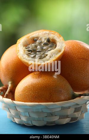 Passion fruits in wicker basket isolated on white Stock Photo - Alamy