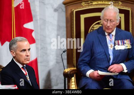Prime Minister Mark Carney listens while touring the Royal Canadian ...