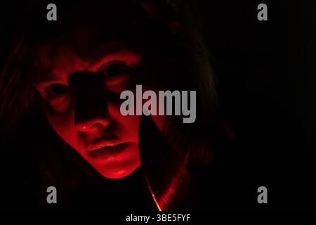 Creepy female portrait in red tones Stock Photo - Alamy